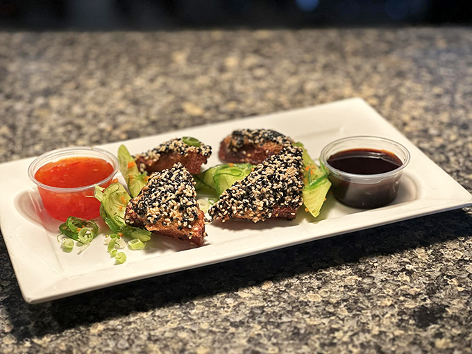 Sesame-crusted tuna bites arrive with two dipping sauces, proving that sometimes the best things come in small, sophisticated packages.