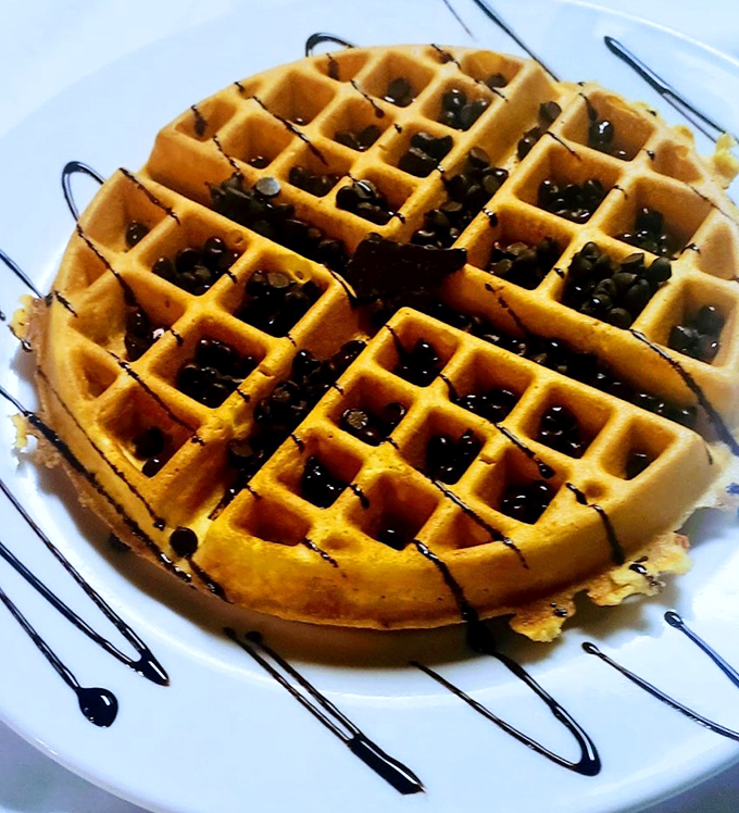 A waffle wearing its Sunday best: perfectly golden, dressed in chocolate drizzle, ready for its breakfast debut.