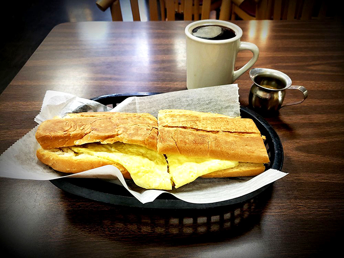 The breakfast sandwich that dreams are made of. Fluffy eggs, crispy bread, and a coffee on the side - morning perfection achieved! Photo credit: Dave S.