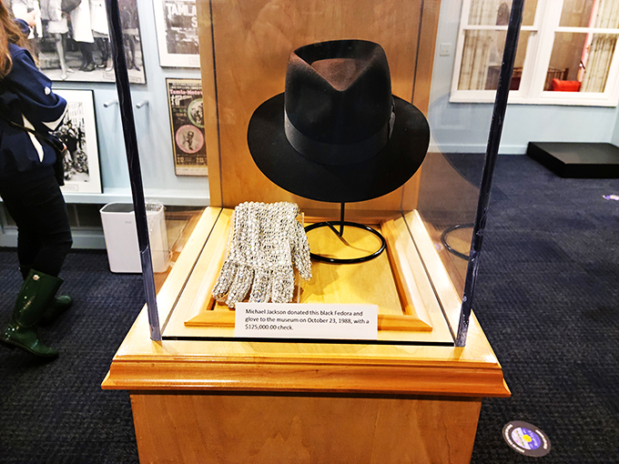 Michael Jackson's iconic fedora and glove sit quietly under glass, still radiating star power after all these years.