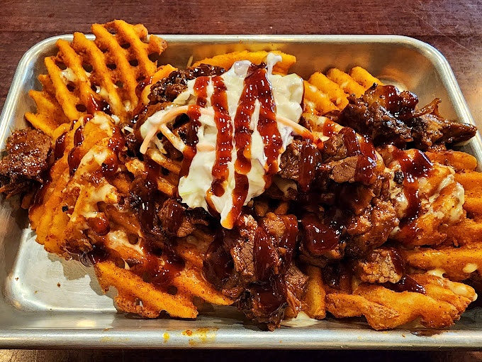 Fries that have been visited by the brisket fairy. This plate is what happens when comfort food decides to dress up for a night out.