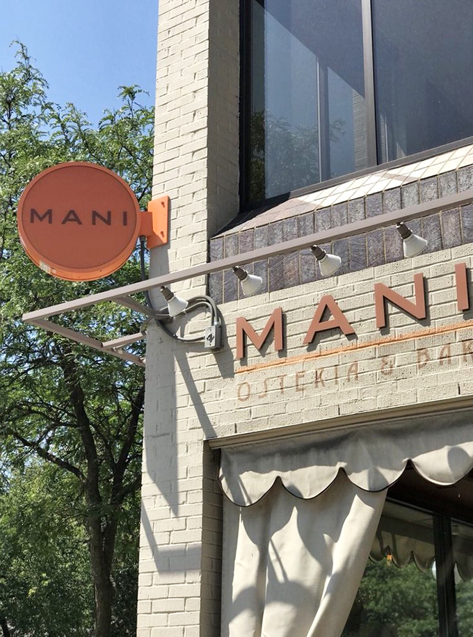 Mani's sign: your beacon to pizza paradise. It's not just illuminating the street, it's lighting the way to your next favorite meal.