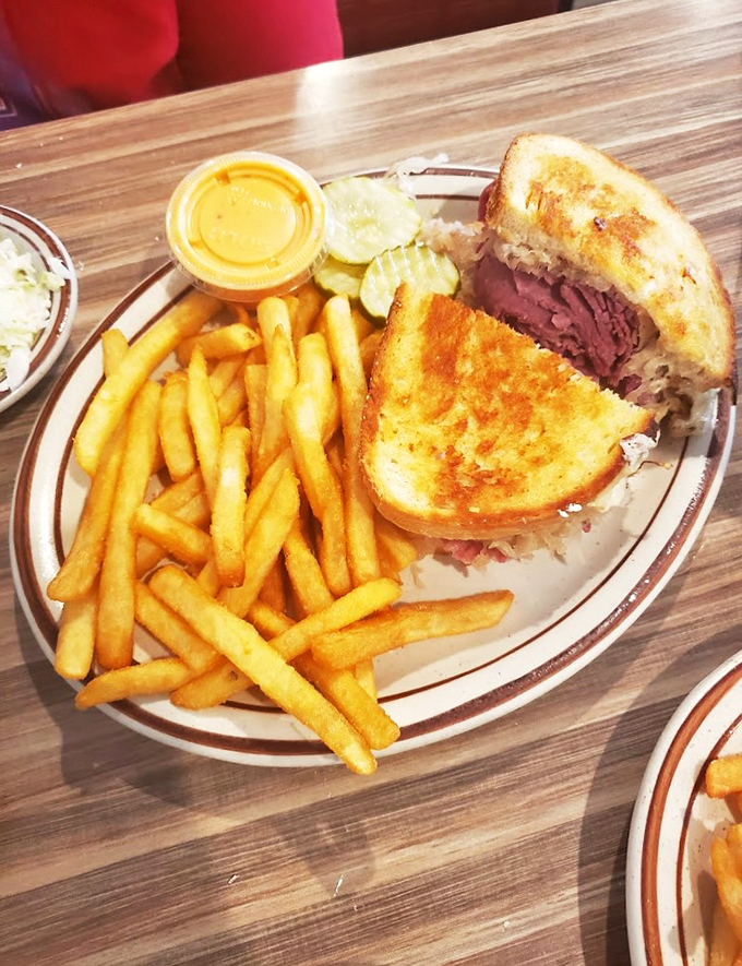 Ladies and gentlemen, I present to you the Reuben sandwich - a tower of deliciousness that laughs in the face of sensible portion sizes.