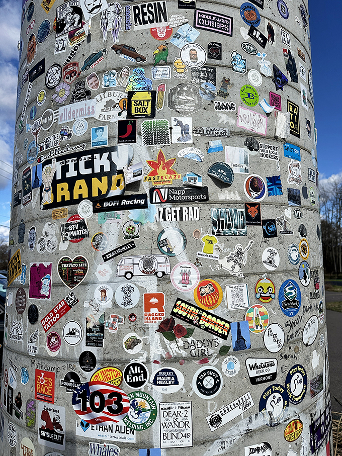 A kaleidoscope of stickers adorns the base. It's like every visitor left a tiny piece of themselves, creating a colorful community collage.