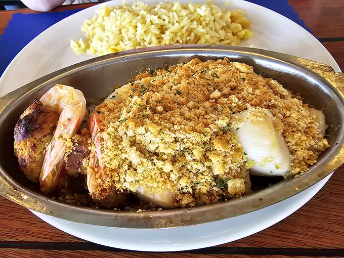 This isn't just dinner &ndash; it's seafood architecture, where haddock and shrimp unite under a golden canopy of crumbs.