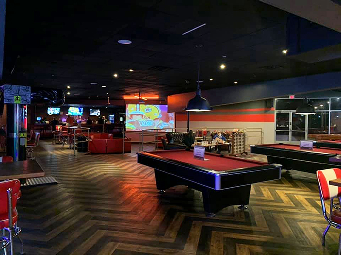 Red and wood tones create a cozy billiards area where friendly competition meets casual comfort.