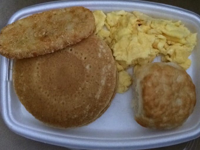 Breakfast fit for a New England morning: fluffy pancakes, scrambled eggs, and sausage served with colonial charm. Photo credit: McDonald's