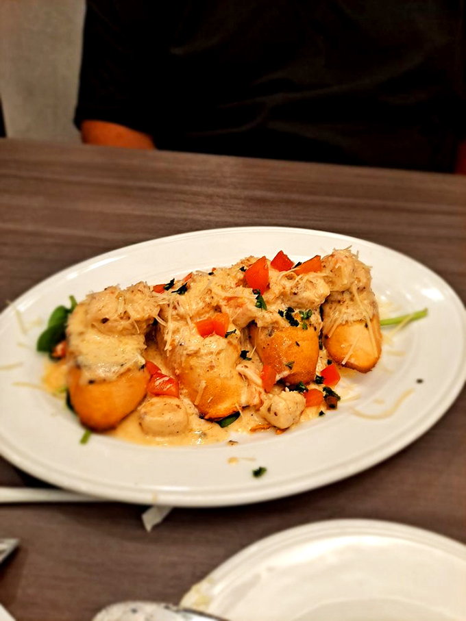 These seafood bites look like they're ready for their close-up, garnished with colorful peppers and fresh herbs.