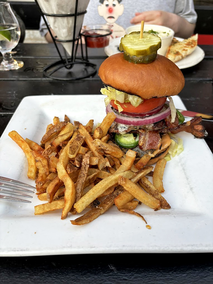 A towering burger that requires a game plan before tackling, accompanied by perfectly crispy fries. Challenge accepted.