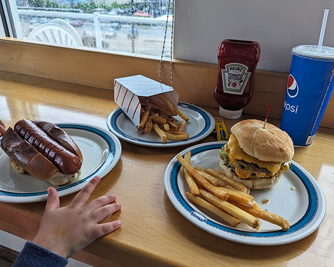 The holy trinity of American cuisine! This burger, hot dog, and fries combo is like a edible Norman Rockwell painting.