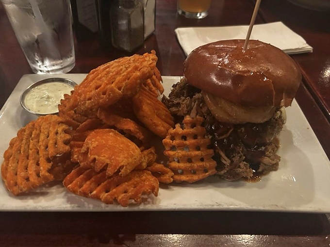 The perfect partnership: a towering burger meets waffle fries in a dance of delicious destiny.