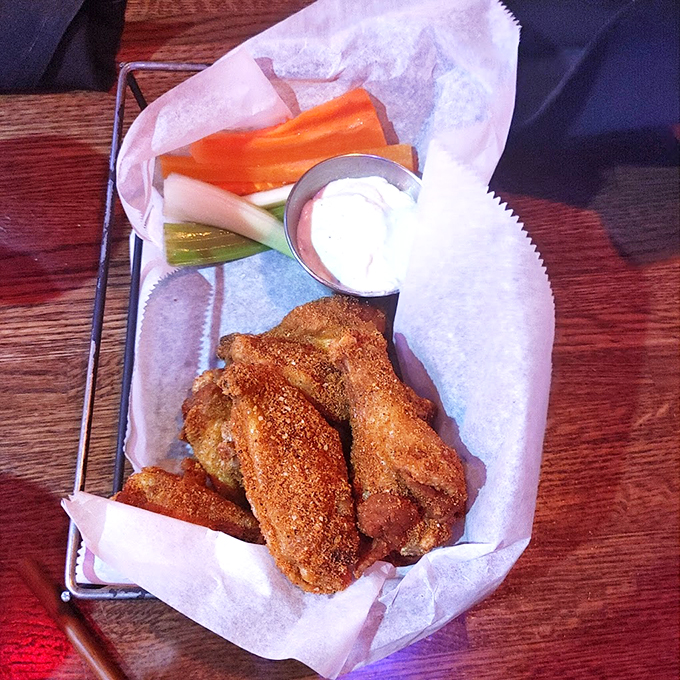 Crispy, golden-brown wings served with fresh veggies - proof that sometimes the classics are classic for a reason.