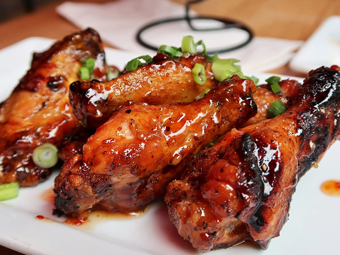 Glazed chicken wings that shine like jewels, proving Bar Harbor's culinary range extends well beyond seafood.