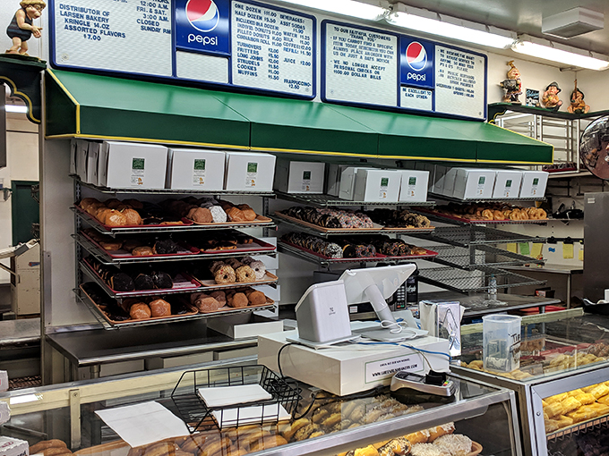 Behind the counter, where the magic happens. It's like Santa's workshop, but with more sugar and less pointy shoes.