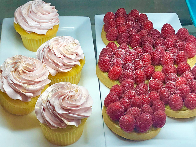A tale of two treats: dainty cupcakes and fruit-laden tarts. It's a tough choice, but someone's gotta make it.