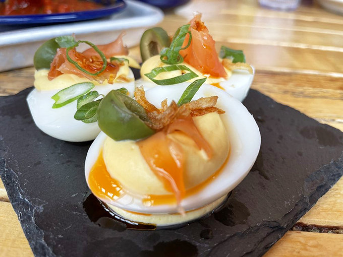 Deviled eggs go on vacation to Mexico and come back with stories to tell, wearing chile oil and crispy garnishes. Photo credit: Joanna R.