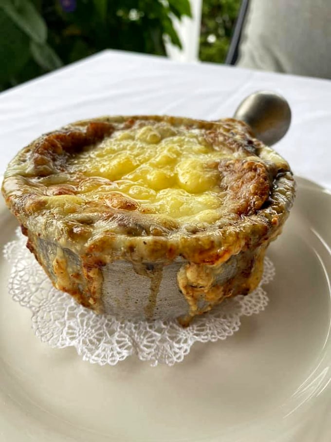 Bubbling cheese meets rich broth in this classic French onion soup, comfort food at its most elegant.