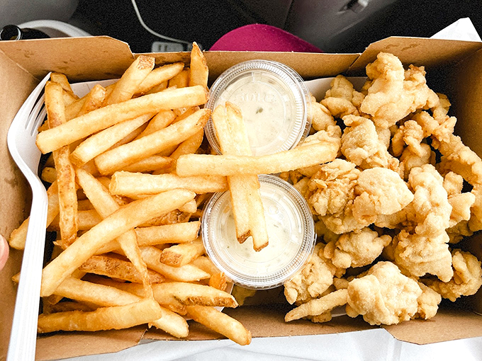 Perfectly golden clams and fries sharing a plate like old friends at a seaside reunion.