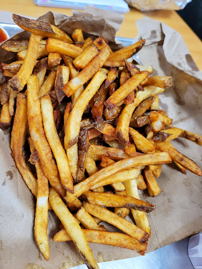 Hand-cut fries that could make a French chef weep with joy, each one perfectly golden and ready for their close-up.