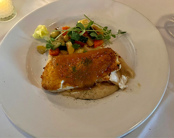 Halibut wearing a golden crust like nature's finest jewelry, surrounded by a rainbow of fresh vegetables. 