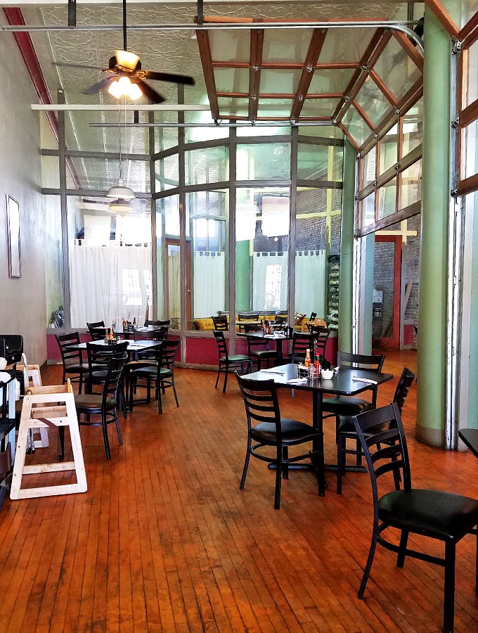 High ceilings and natural light create an airy dining space that makes every meal feel like a special occasion.