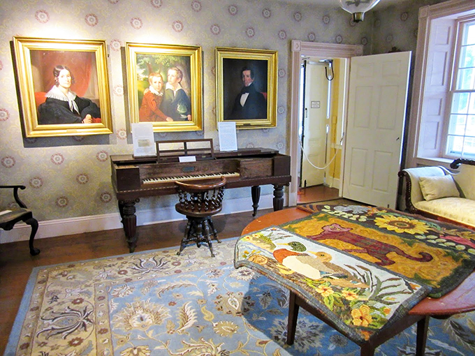 Period portraits watch over antique furnishings, while colorful hooked rugs add warmth to this slice of history.