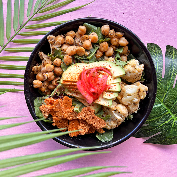 A garden party in a bowl, where roasted chickpeas and fresh veggies dance with pickled onions and avocado.