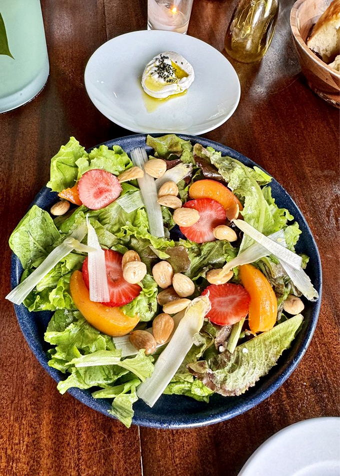 A garden party on a plate - fresh strawberries and nuts dance among crisp greens in this vibrant salad. Photo credit: Cristina R.