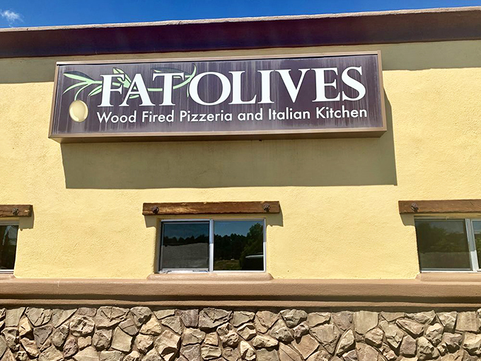 The sign says it all: Wood-fired dreams and Italian schemes await behind these sunny yellow walls.