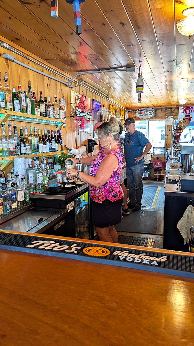 Behind the bar, where lobster tales become cocktail legends. This mixologist could probably make a mean drink out of seawater if you asked nicely.