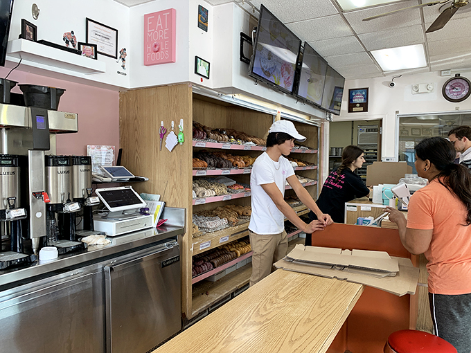 The unsung heroes of the donut world! These folks are like Santa's elves, but instead of toys, they're crafting edible joy.