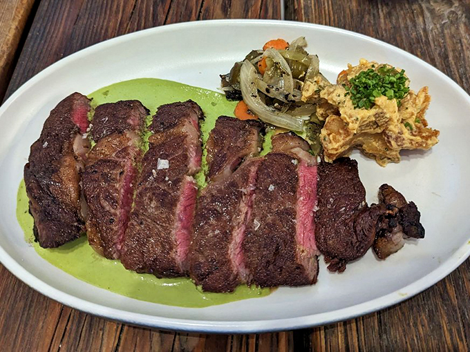 This steak isn't just rare - it's uncommonly good, resting on a bed of verdant sauce like a meaty masterpiece. Photo credit: Betsy L.
