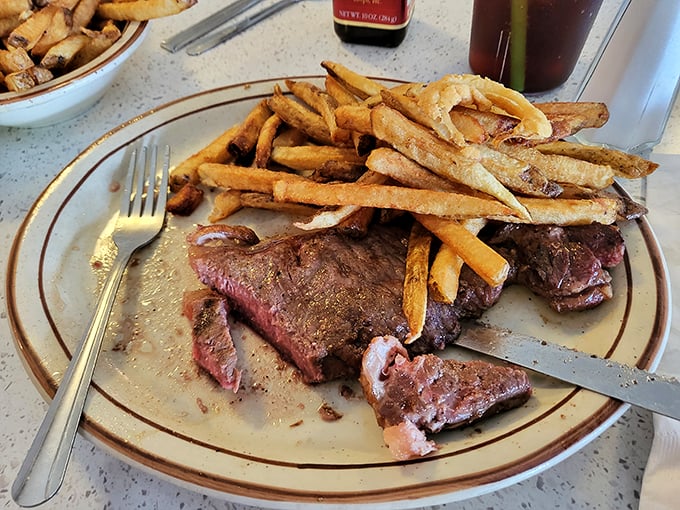 Steak and fries: the dynamic duo of diner cuisine. This plate screams "treat yourself" louder than a self-help guru.