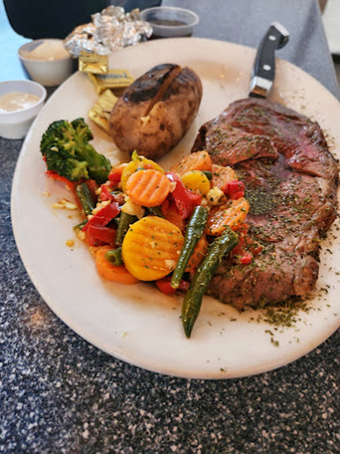 Perfectly grilled steak shares the spotlight with vibrant seasonal vegetables and a loaded baked potato. 