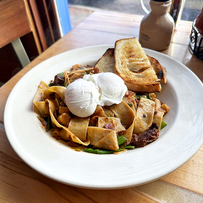 Wide rice noodles dance with tender beef under two perfectly poached eggs - fusion food at its finest.