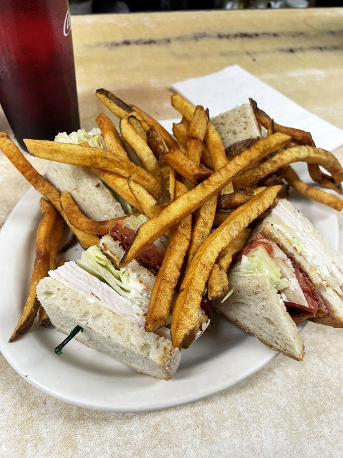 The classic club sandwich: where turkey, bacon, and veggies come together in perfect harmony. It's like a delicious game of Jenga!