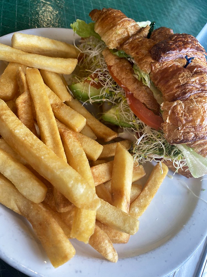 A golden, flaky croissant loaded with fresh ingredients - proof that simple things done right are simply perfect.