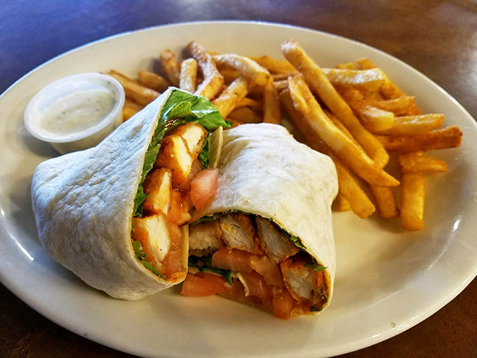 This wrap means business - packed with fresh ingredients and served with perfectly golden fries and house-made sauce. Photo credit: 5th Avenue Cafe