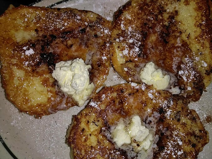 French toast that's more indulgent than a Parisian vacation. Crispy on the outside, custardy on the inside, and topped with enough powdered sugar to make a snowman jealous.