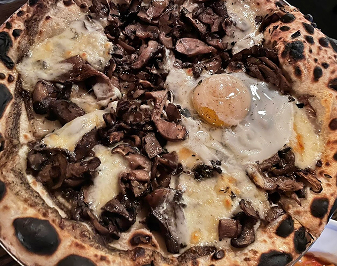 Egg-cellent addition! This mushroom pizza with a sunny-side-up surprise is breakfast, lunch, and dinner all in one delicious dish.