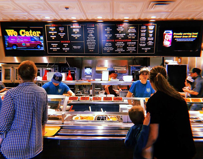 The barbecue assembly line! These folks are slinging meat faster than gossip at a church picnic.