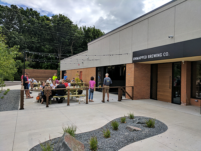 Unmapped's inviting patio. Bask in the glow of their neon sign while sipping stellar brews &ndash; it's an Instagram moment waiting to happen.