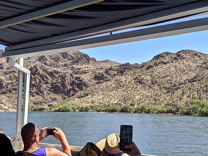 Saguaro selfie central! Passengers snap away, trying to capture a view that's more breathtaking than a cactus hug.