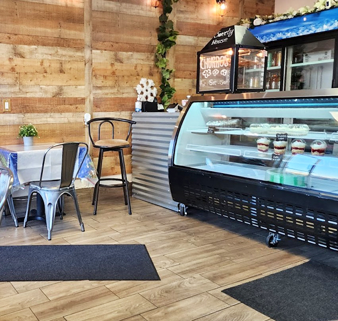 Wooden walls, metal chairs, and soft lighting create a modern yet cozy spot perfect for dessert dates.