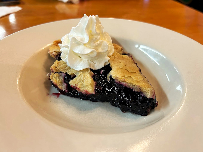 Wild Maine blueberries tucked under a flaky crust, crowned with a cloud of whipped cream.