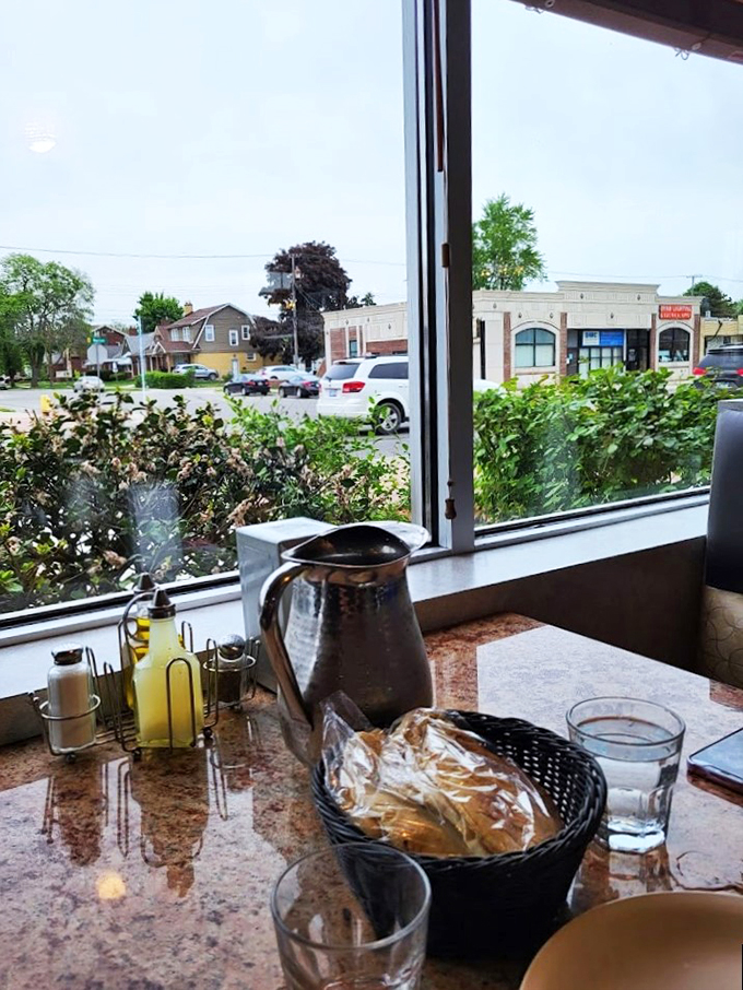 Window-side dining with a view, where warm pita and house-made garlic sauce make every meal feel special.