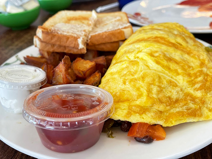 An omelet so fluffy it could double as a pillow, paired with perfectly golden home fries.