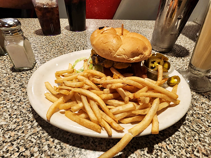 This burger isn't just a meal, it's a masterpiece of American cuisine. Those jalape&ntilde;os are standing guard like tasty sentinels. Photo credit: tommy balli