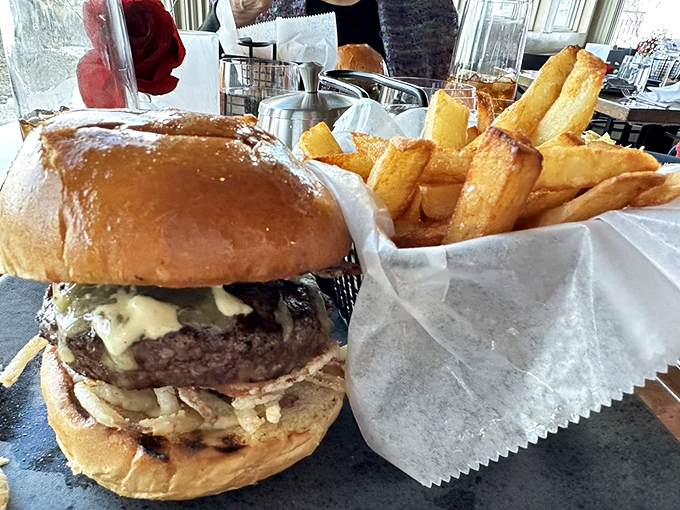 This burger means business &ndash; thick, juicy, and accompanied by fries that could start their own fan club. Photo credit: John Z.