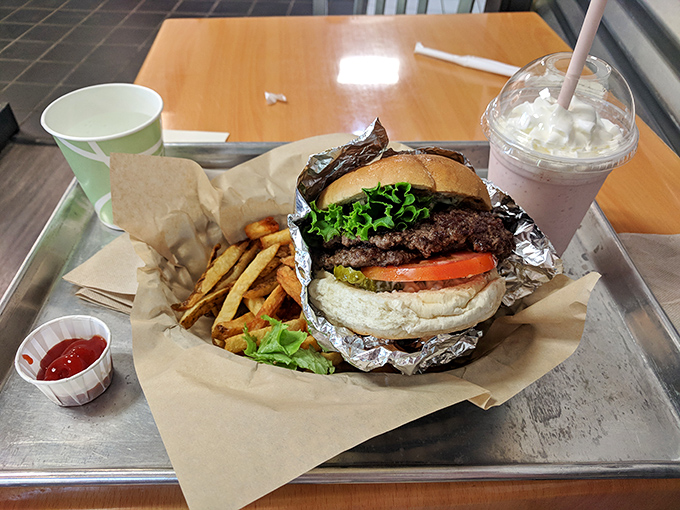 A burger that means business, accompanied by fries that clearly graduated from potato university with honors.